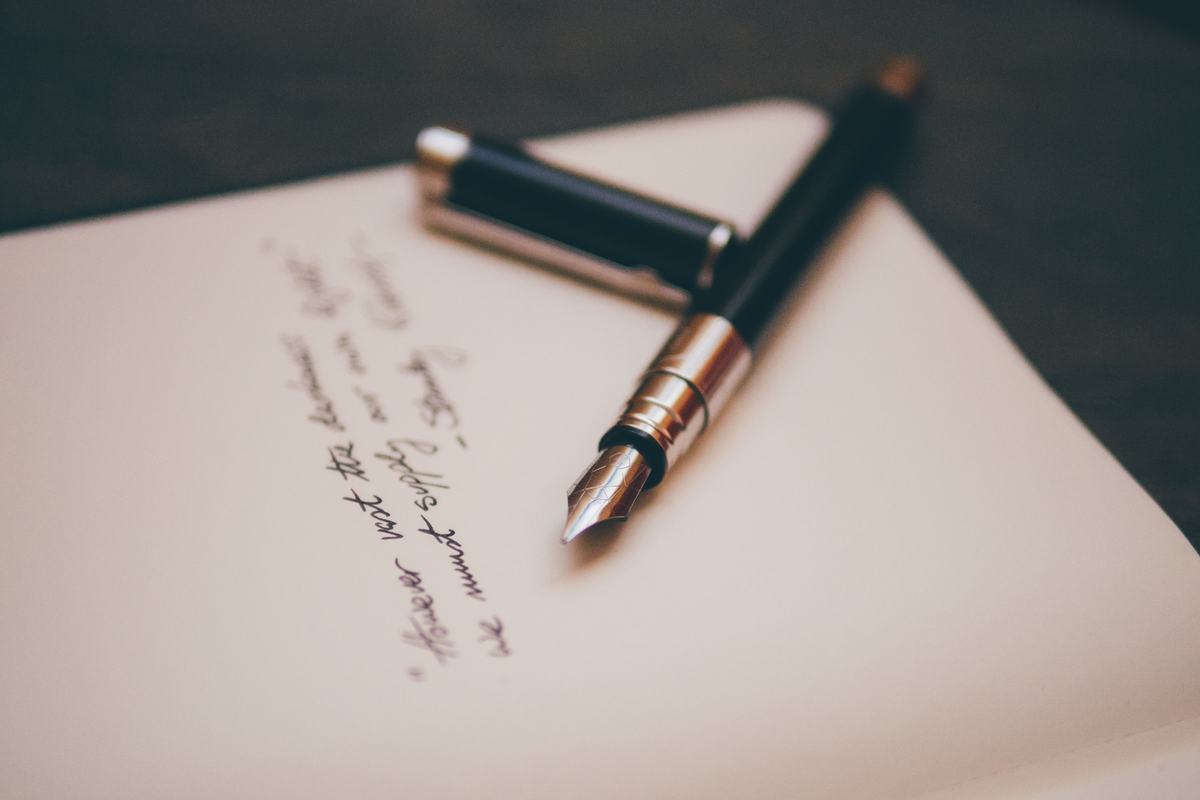 Free Photo: An Opened Pen with Some Handwritten Text