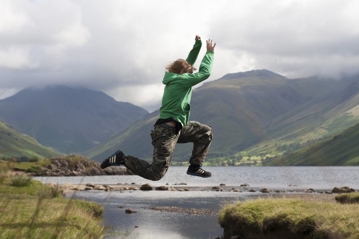 Free Photo: Young Boy Jumping Over the Mountains Lake Water