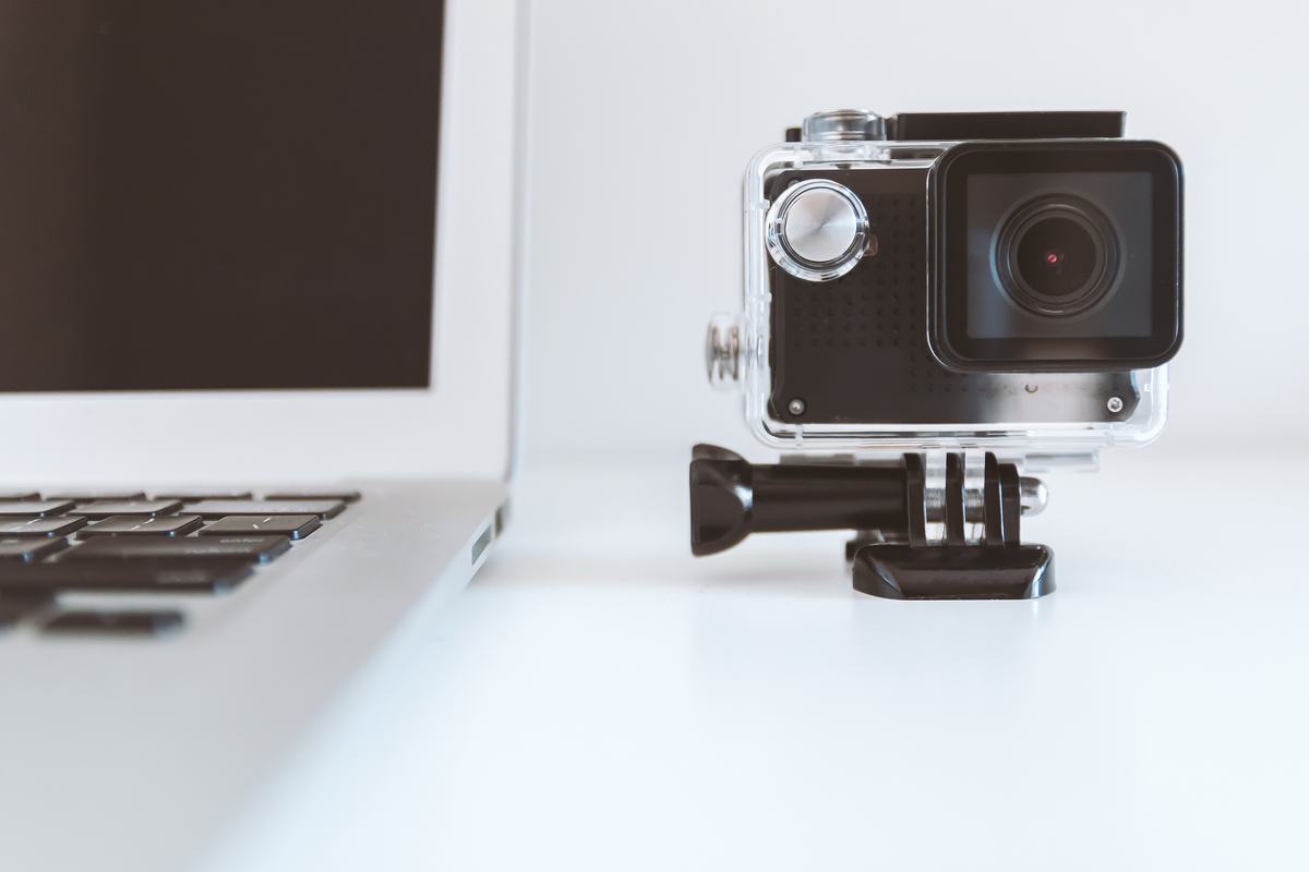 Free Photo: Close up of MacBook and camera GoPro on white Background