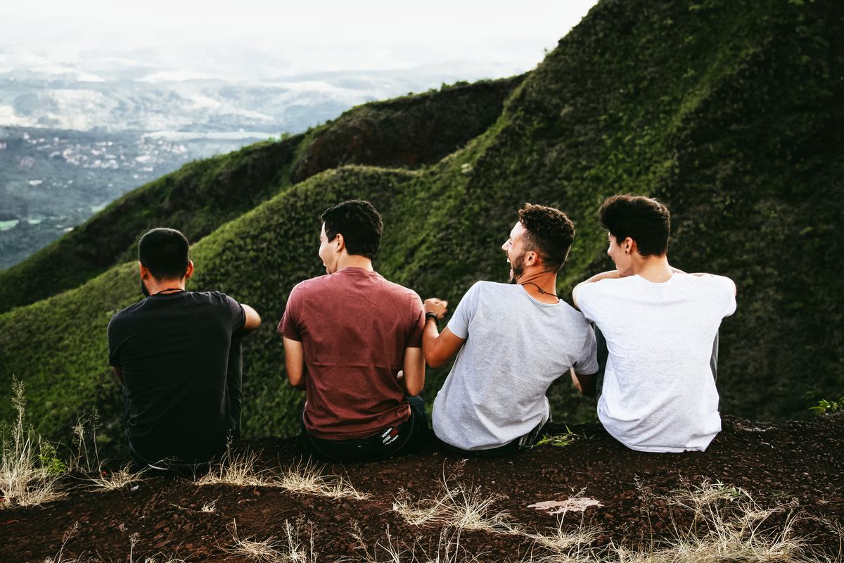 Free Photo: Four Guys Sitting on Cliff and Talking and Laughing