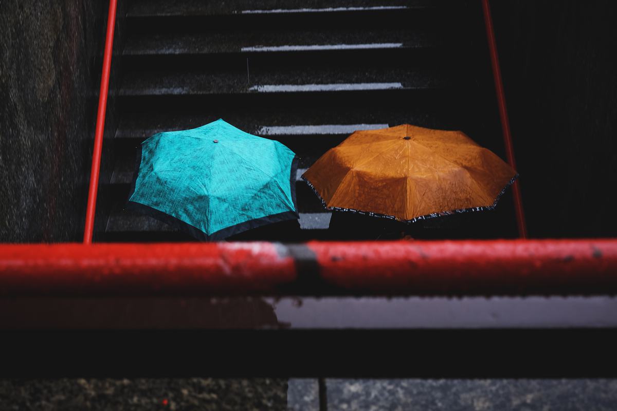 Free Photo: People with Umbrellas Walking Up the Stairs