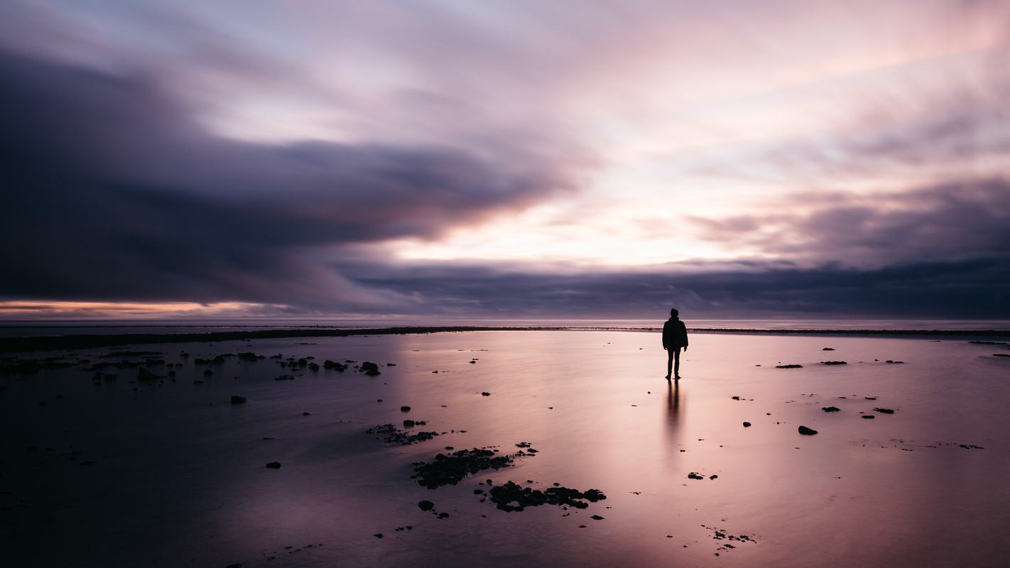 Free Photo: Stunning Long Exposure Sunset Shot Man on the Beach
