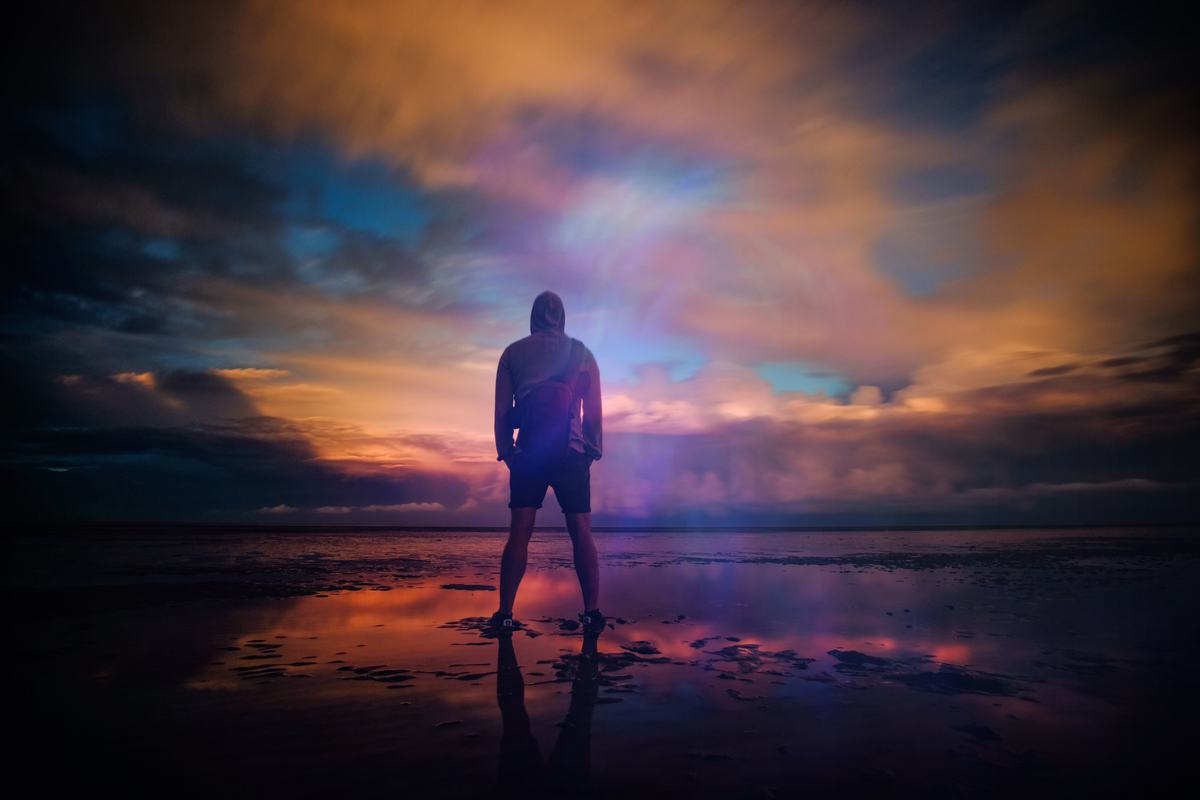 Free Photo: Man Standing behind the Background of a Stunning Sunset